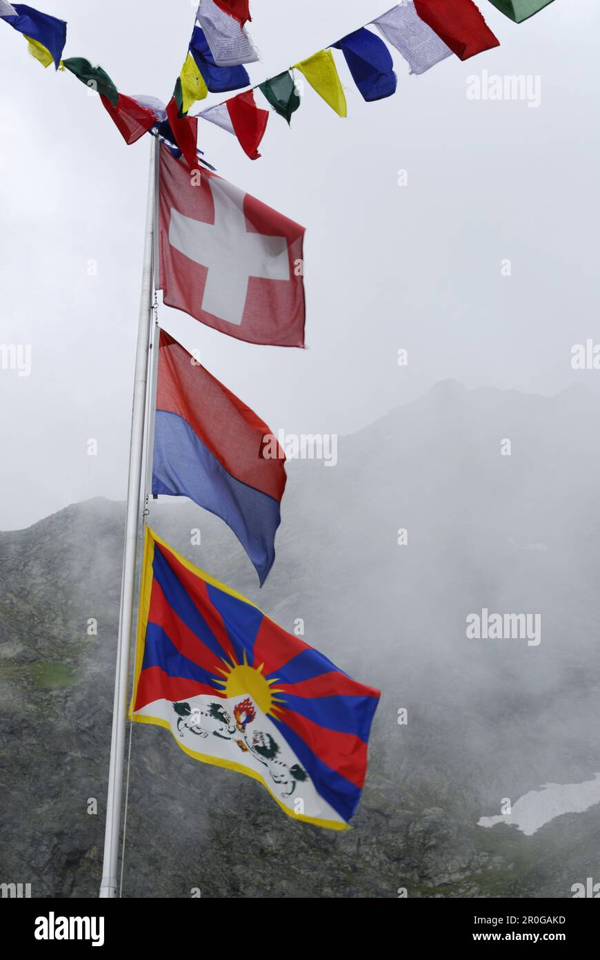 Flagpole with prayer flags and flags, Ticino Alps, Canton of Ticino ...