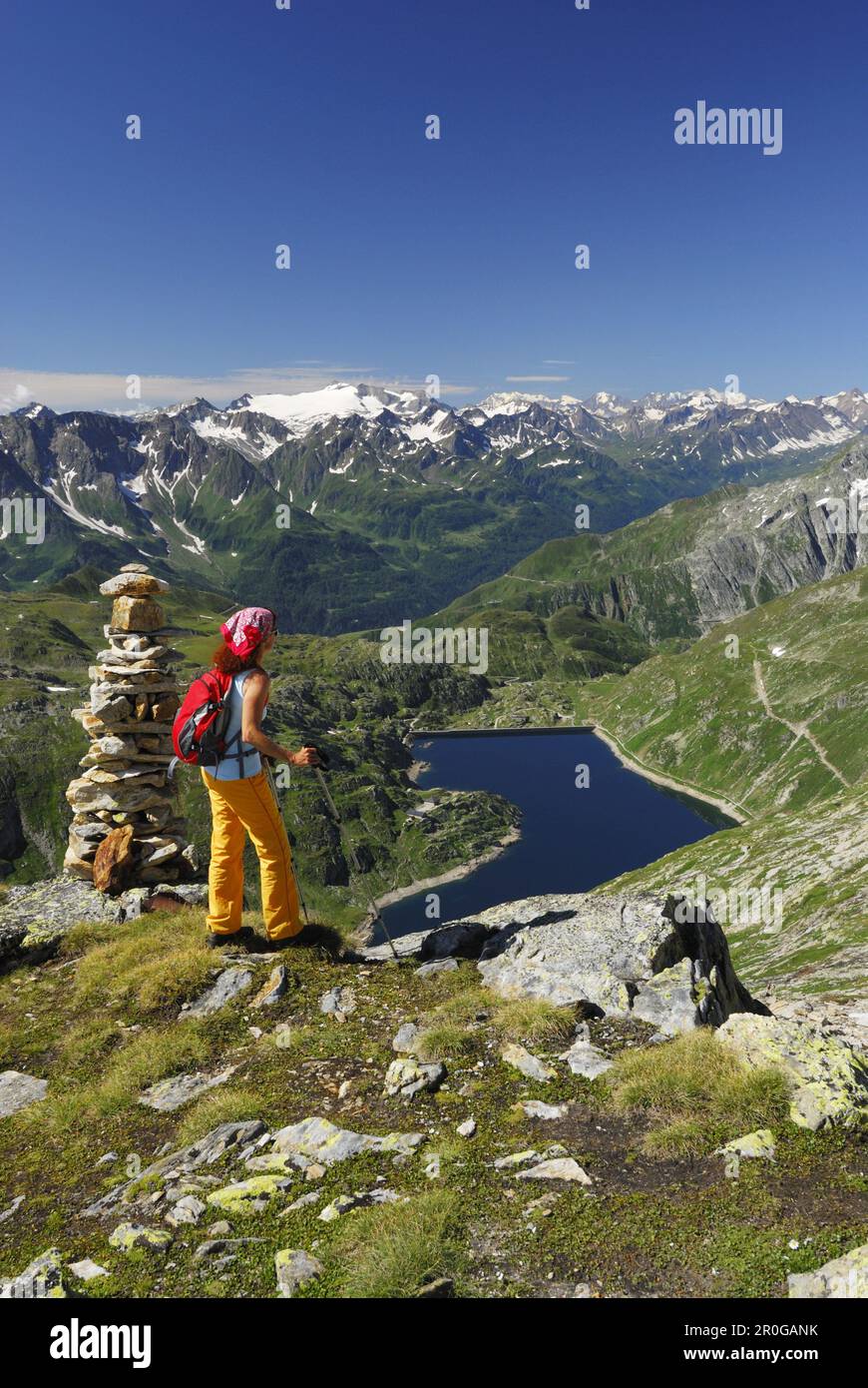Woman looking over reservoir Lago della Sella to Ticino Alps, Gotthard ...