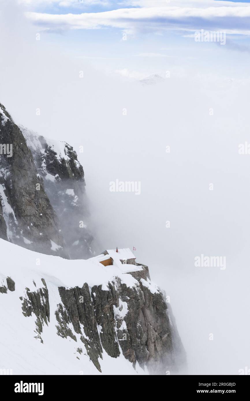 Mountain lodge Cabane de l'A Neuve in fog, Val Ferret, Canton of Valais ...