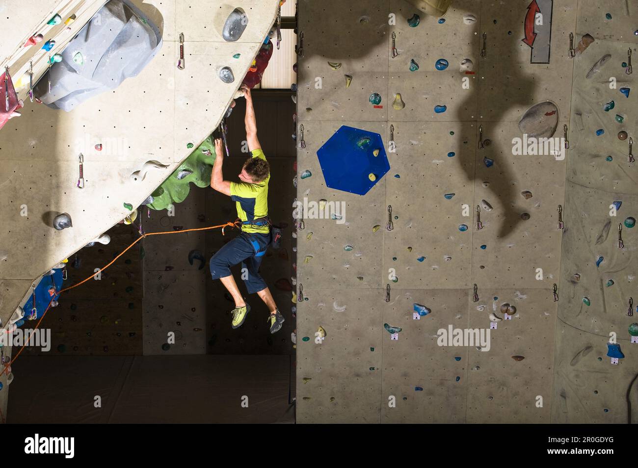 Man climbing on a overhang inside a climbing gym, Linz, Upper Austria ...