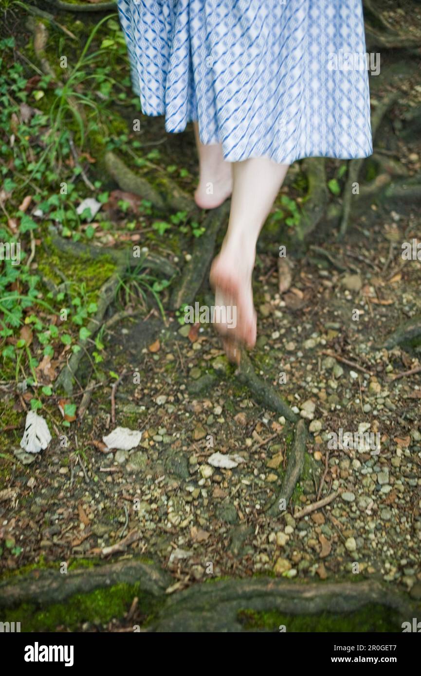 Barefoot woman walking across forest floor, Bavaria, Germany Stock ...
