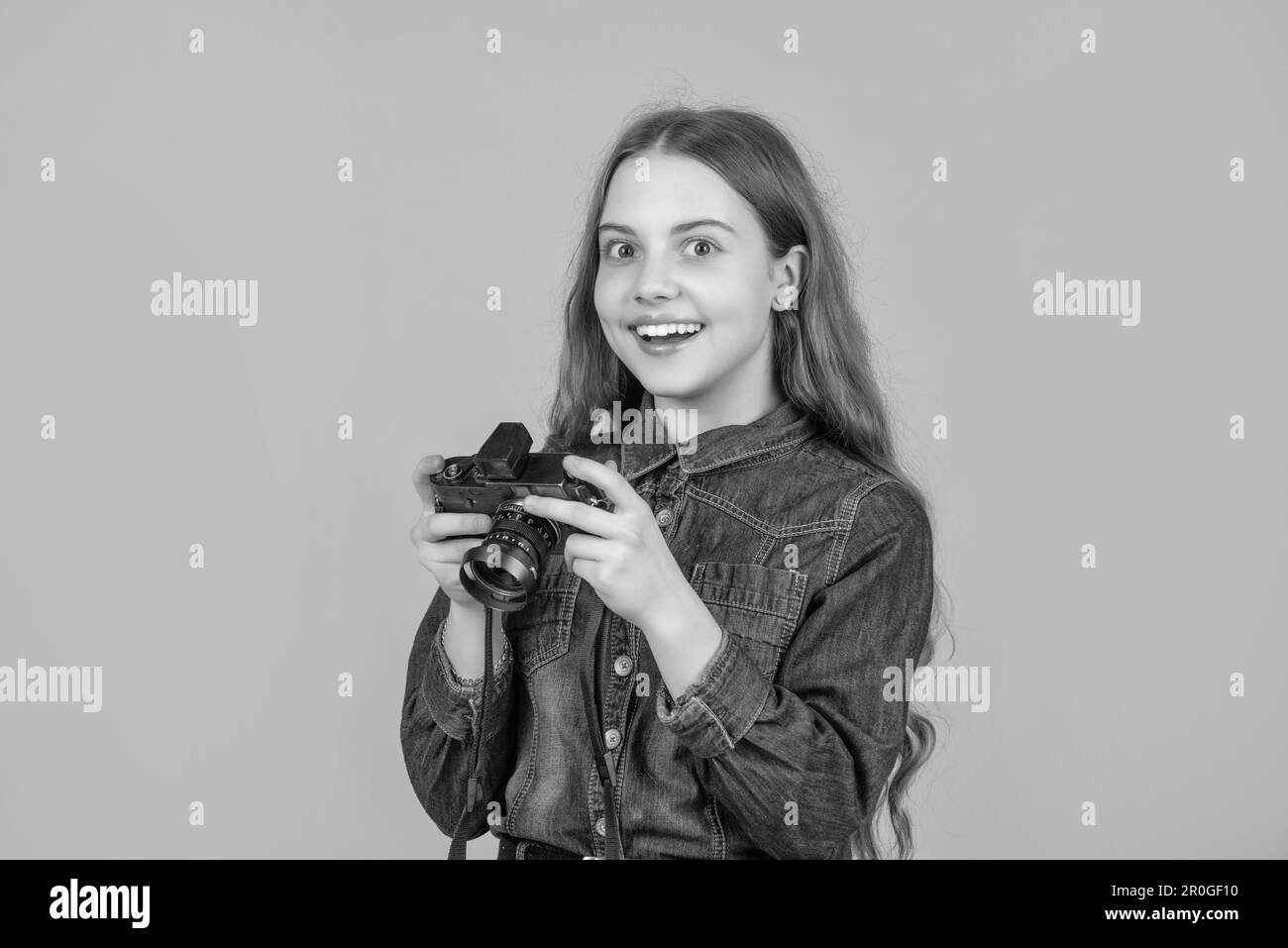 Wow. Surprised teen photographer yellow background. Teen girl holding ...