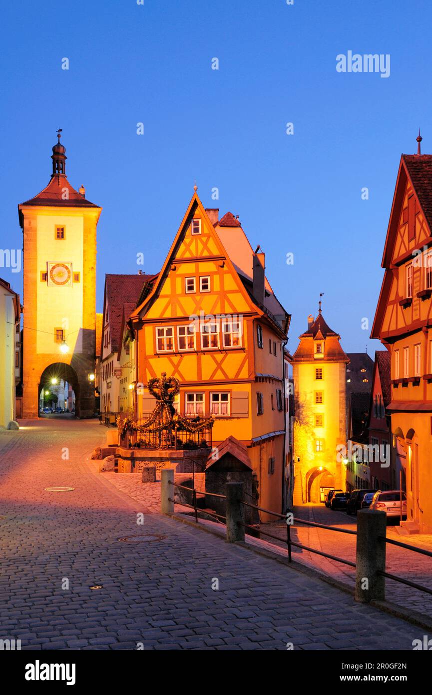 Illuminated Ploenlein with Sieberstor city gate at night, Rothenburg ob ...