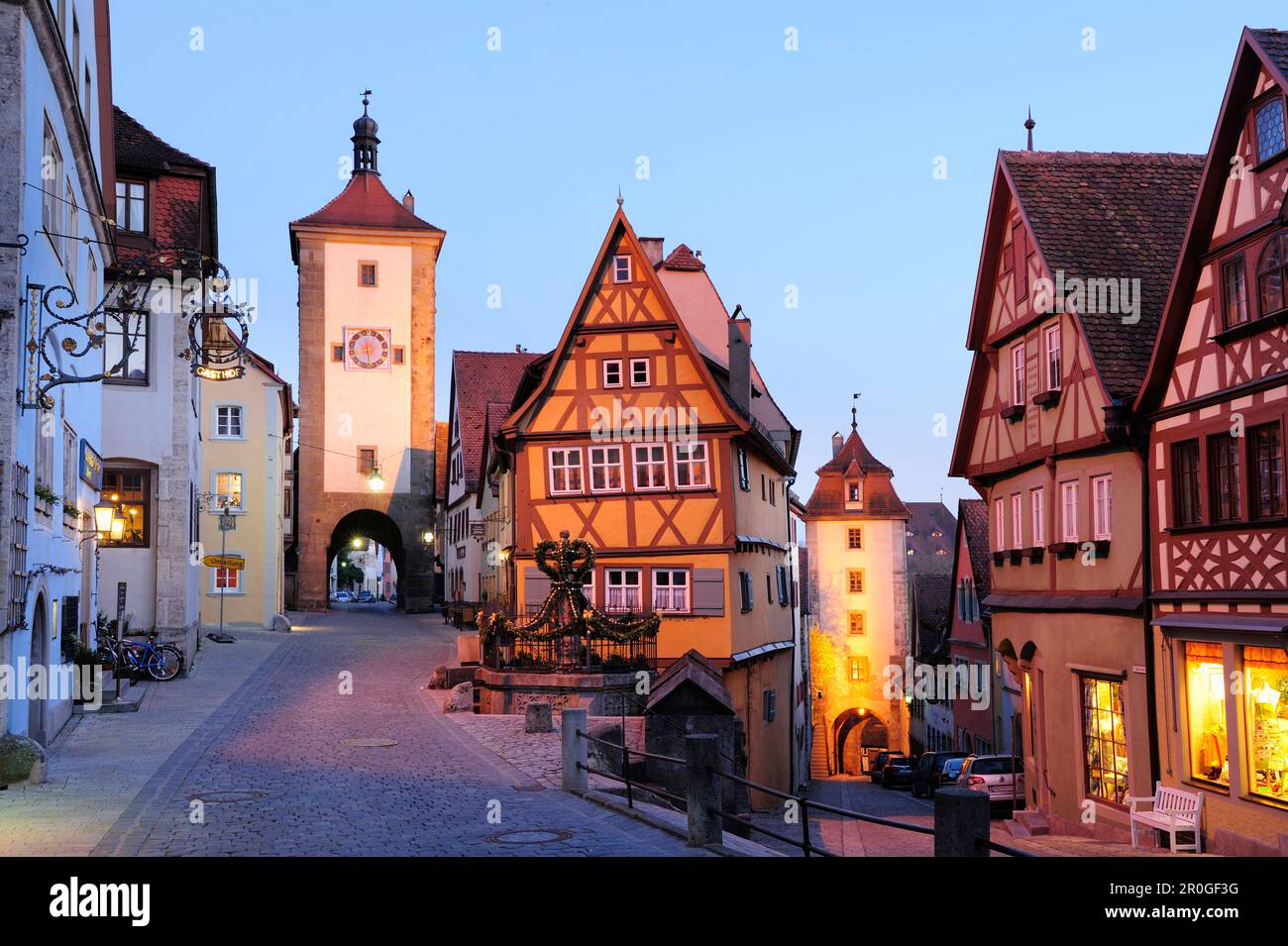 Illuminated Ploenlein with Sieberstor city gate in the evening light ...