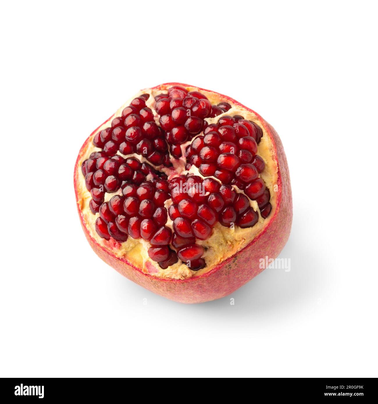 Ripe pomegranate fruit peeled on a white background top view close-up ...