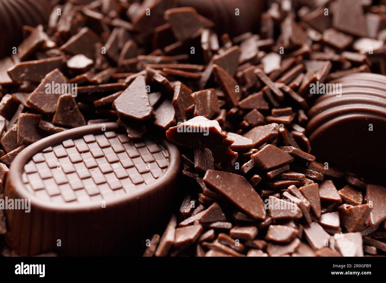 Beautifully shaped dark chocolate sweets dipped in chocolate chips ...