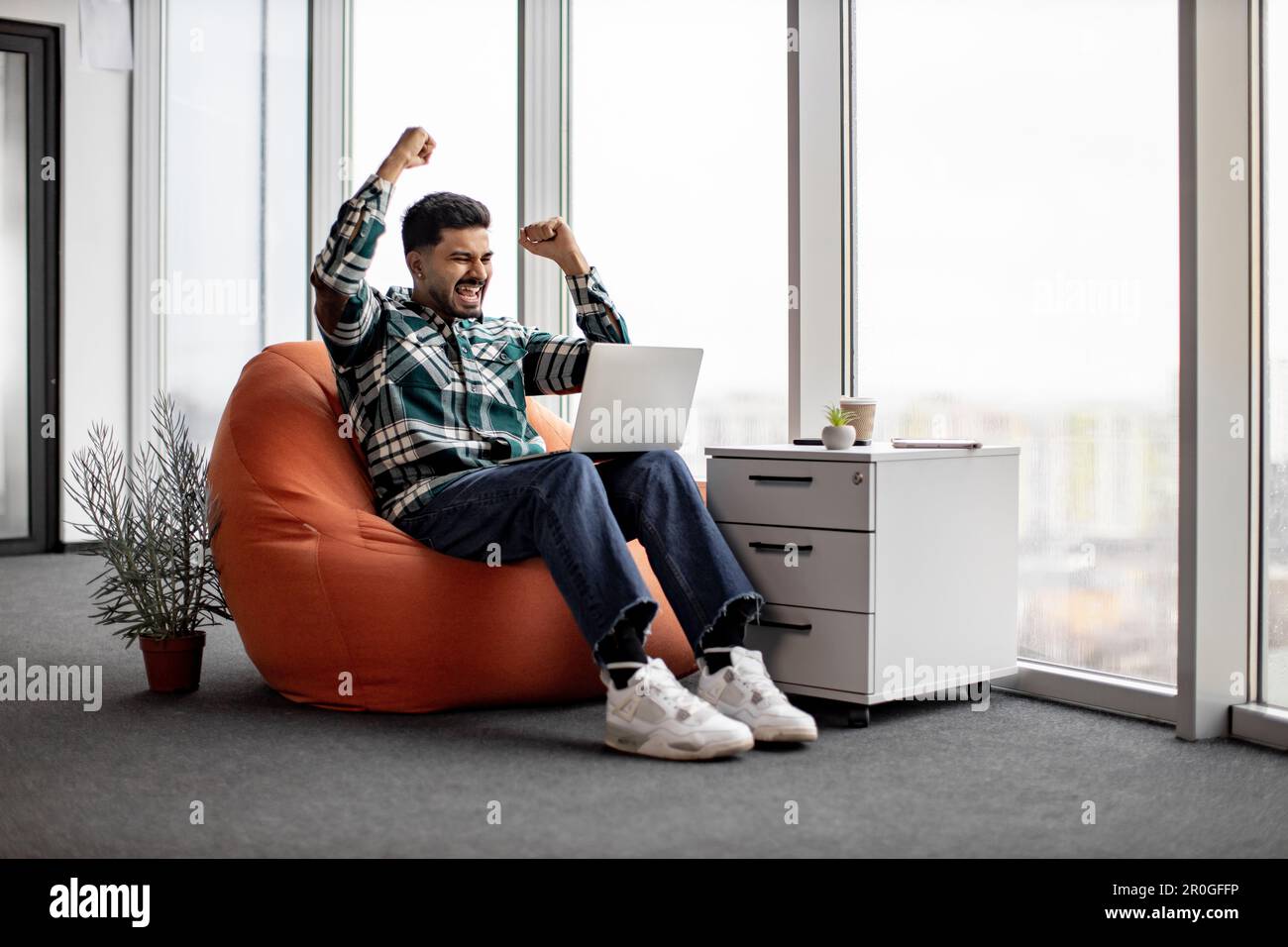 Excited indian worker celebrating great achievement in career. Ecstatic ...