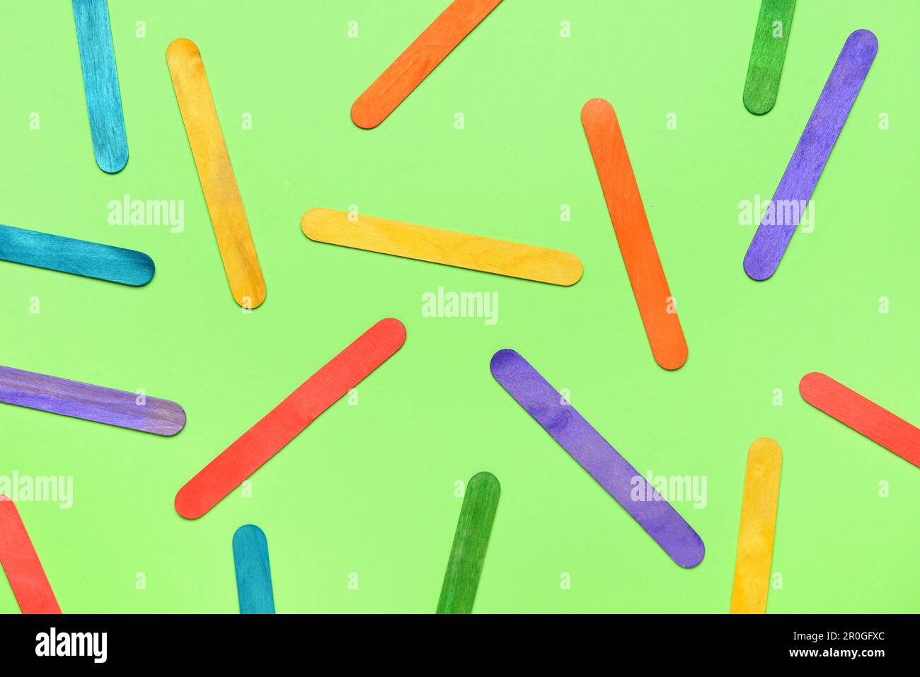 Colorful ice cream sticks on green background Stock Photo - Alamy