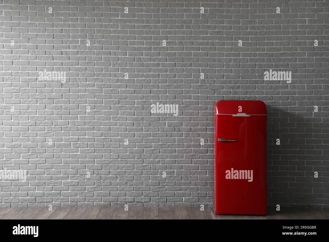 Stylish refrigerator near brick wall in kitchen Stock Photo - Alamy