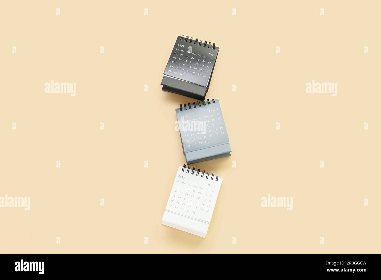 Flip paper calendars on beige background Stock Photo - Alamy
