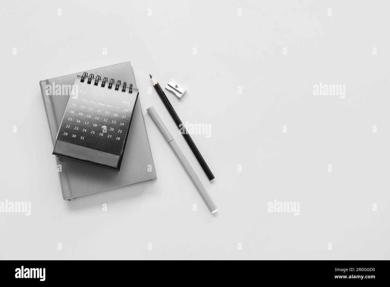 Flip paper calendar for May and stationery on grey background Stock ...