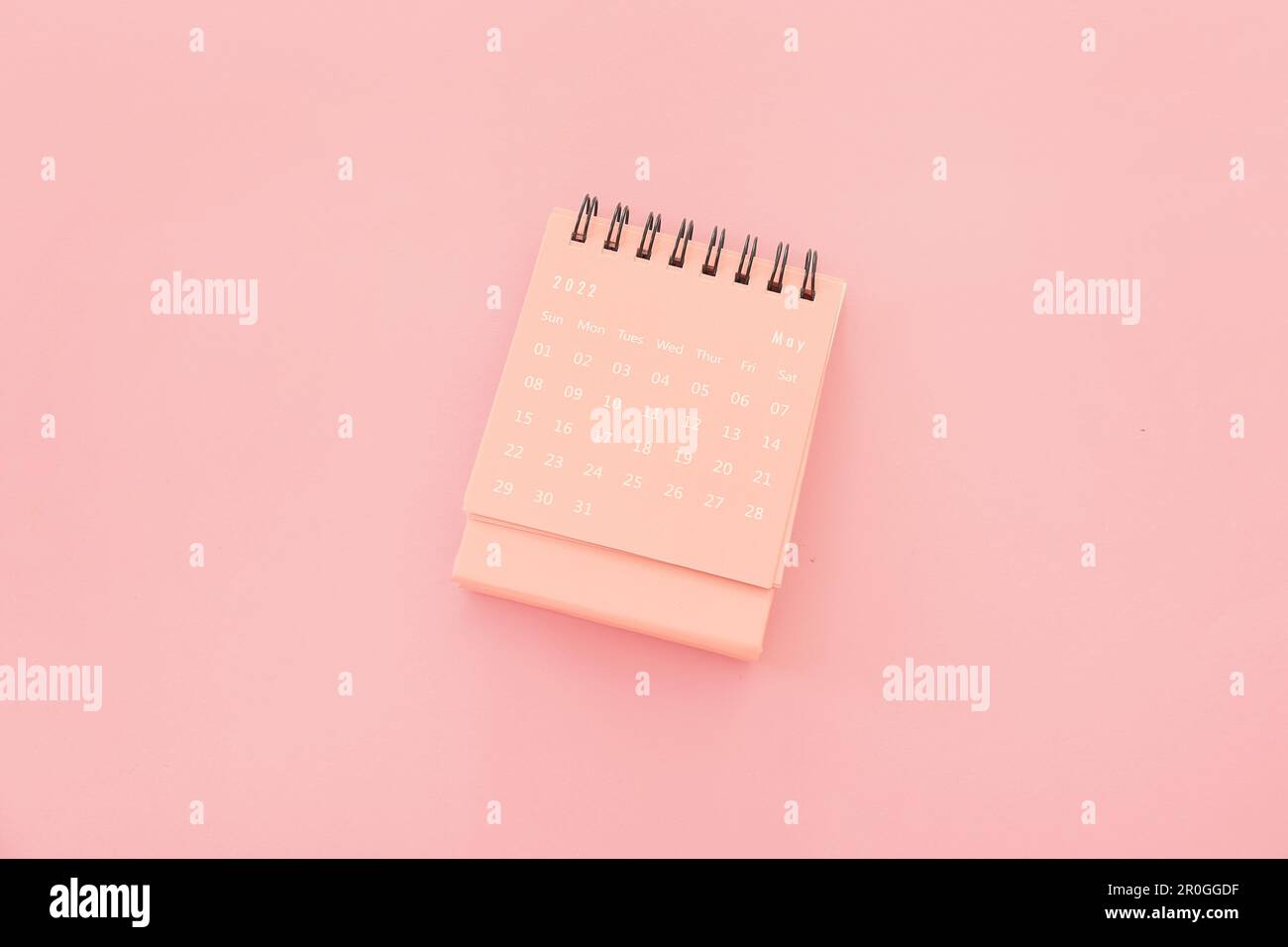Flip paper calendar for May on pink background Stock Photo - Alamy