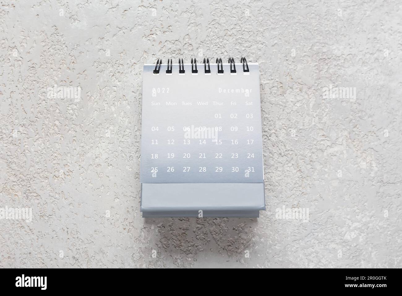 Flip paper calendar for December on grey background Stock Photo - Alamy