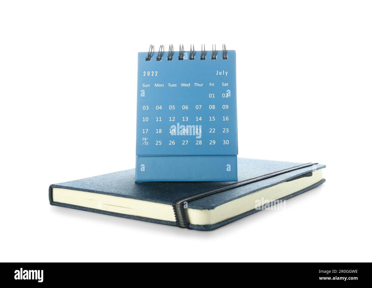 Flip paper calendar for July and notebook on white background Stock ...