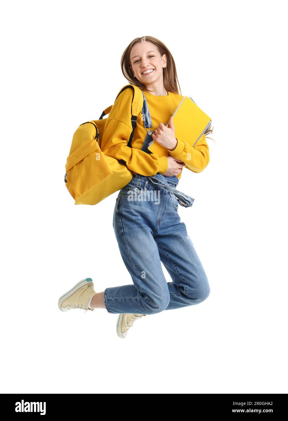 Female student with notebooks jumping on white background Stock Photo ...