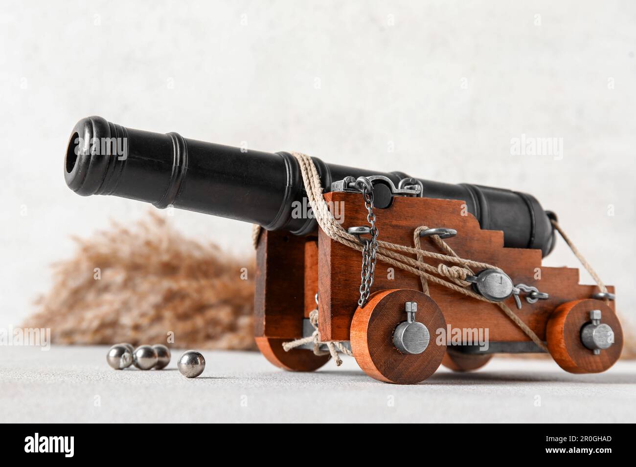 Toy model of cannon on light background Stock Photo - Alamy
