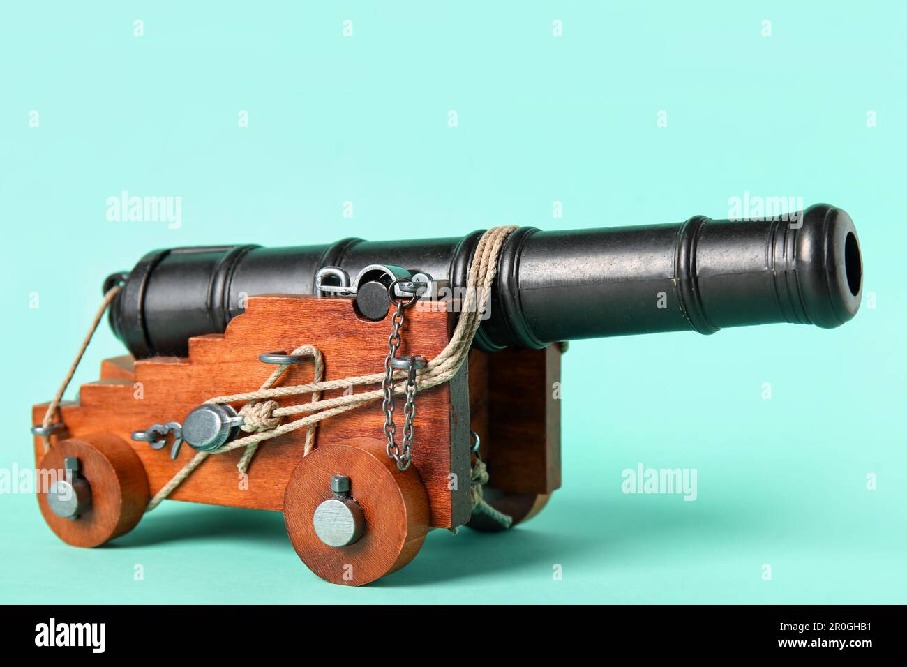 Toy model of cannon on turquoise background Stock Photo - Alamy
