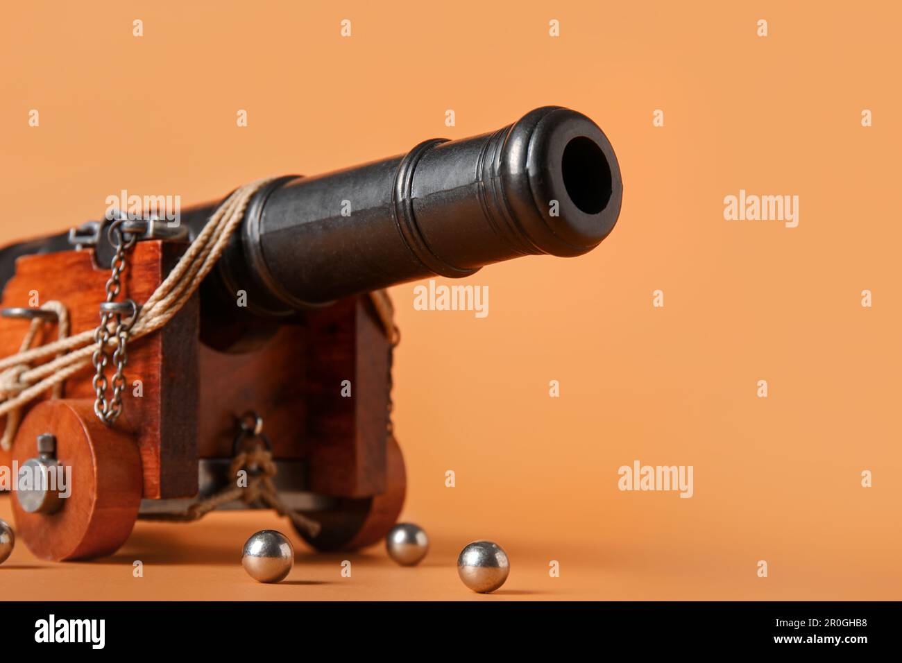 Toy model of cannon on orange background, closeup Stock Photo - Alamy