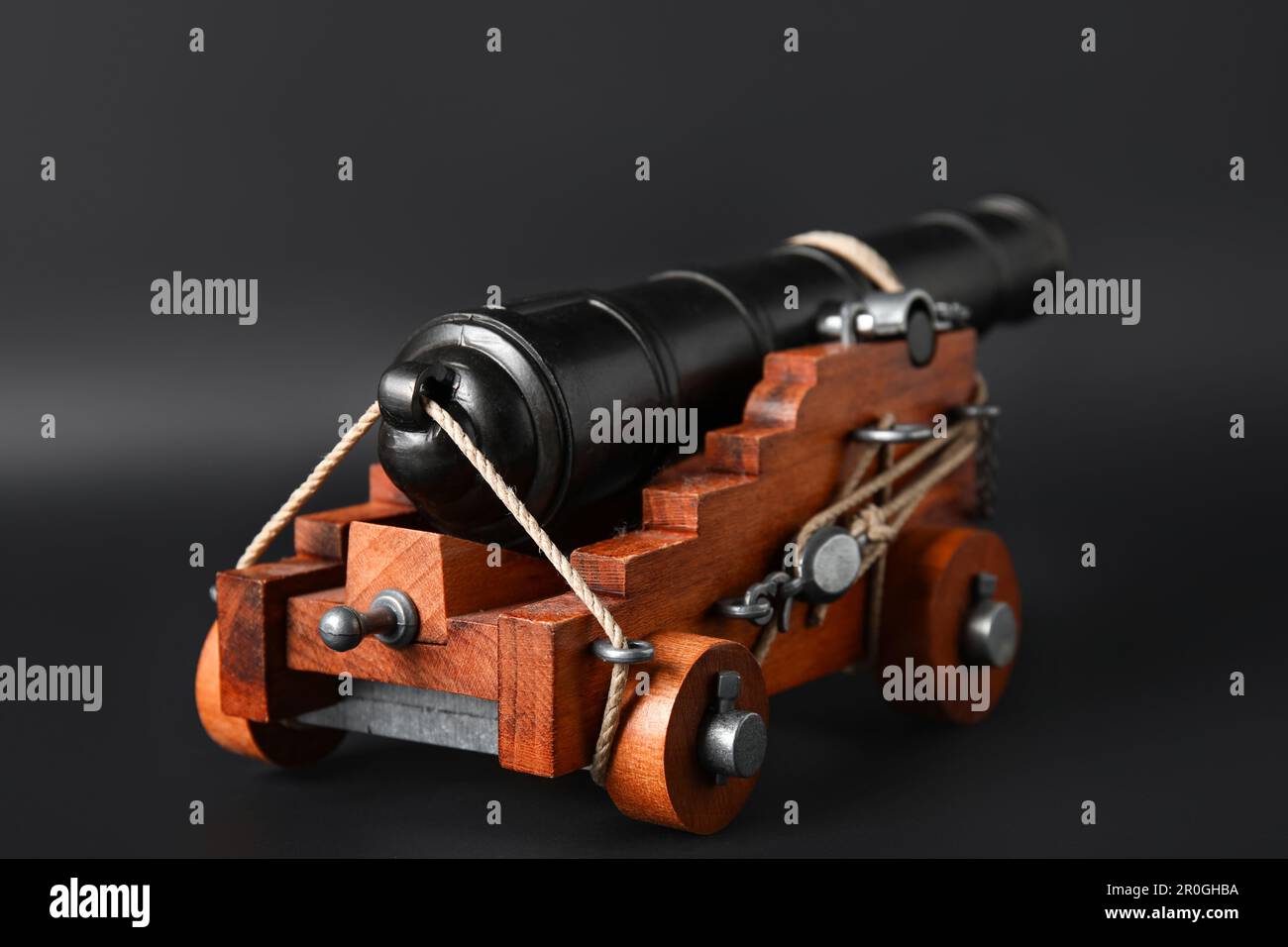 Toy model of cannon on black background Stock Photo - Alamy