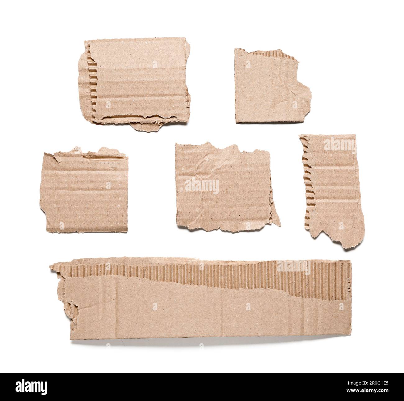 Torn pieces of cardboard isolated on white background Stock Photo - Alamy