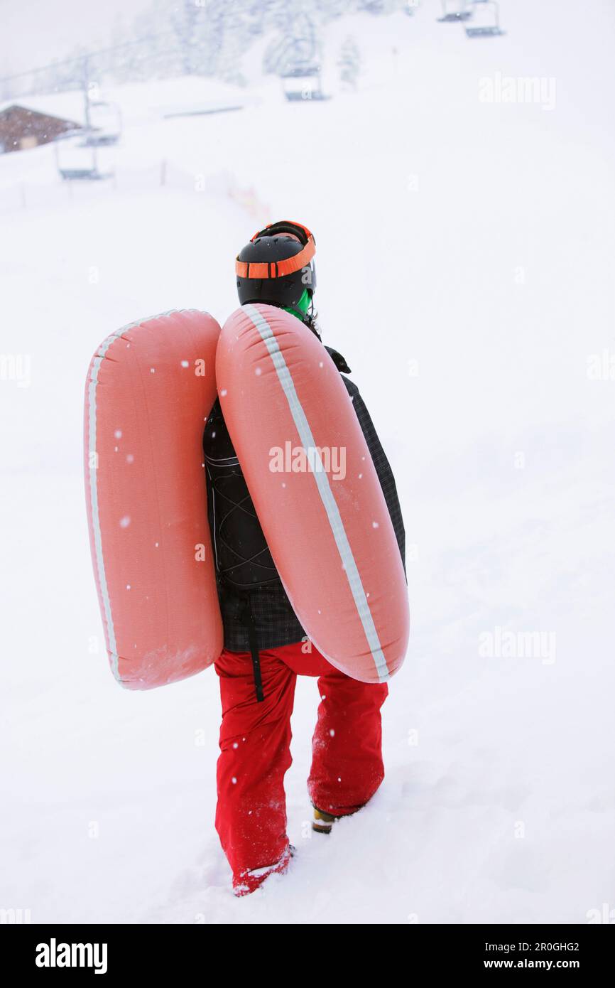 Male free skier with inflated avalanche airbag, Mayrhofen, Ziller river ...