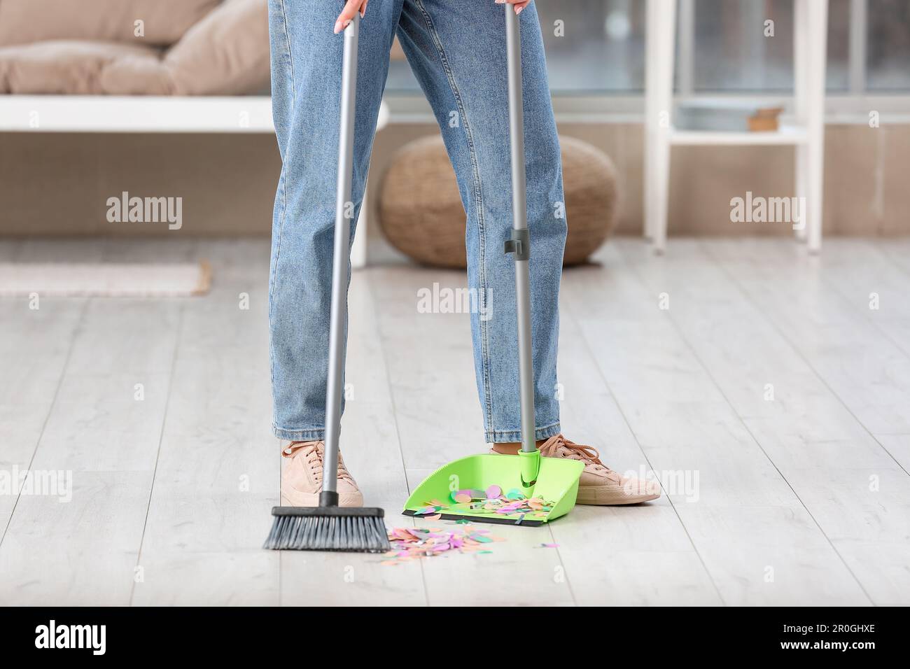 Young woman sweeping floor hi-res stock photography and images - Alamy