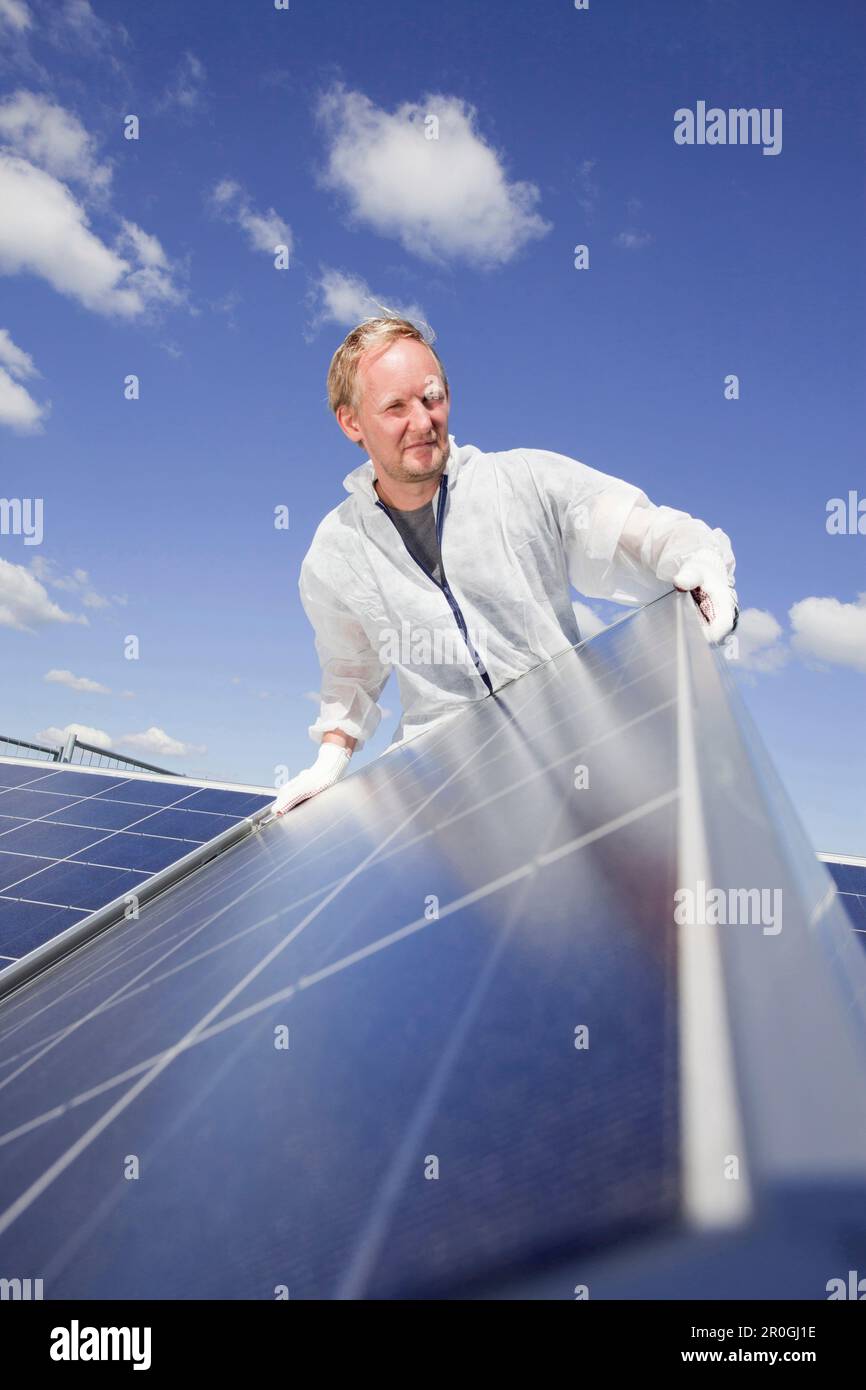 Technician installing a photovoltaic power plant, Hamburg, Germany ...