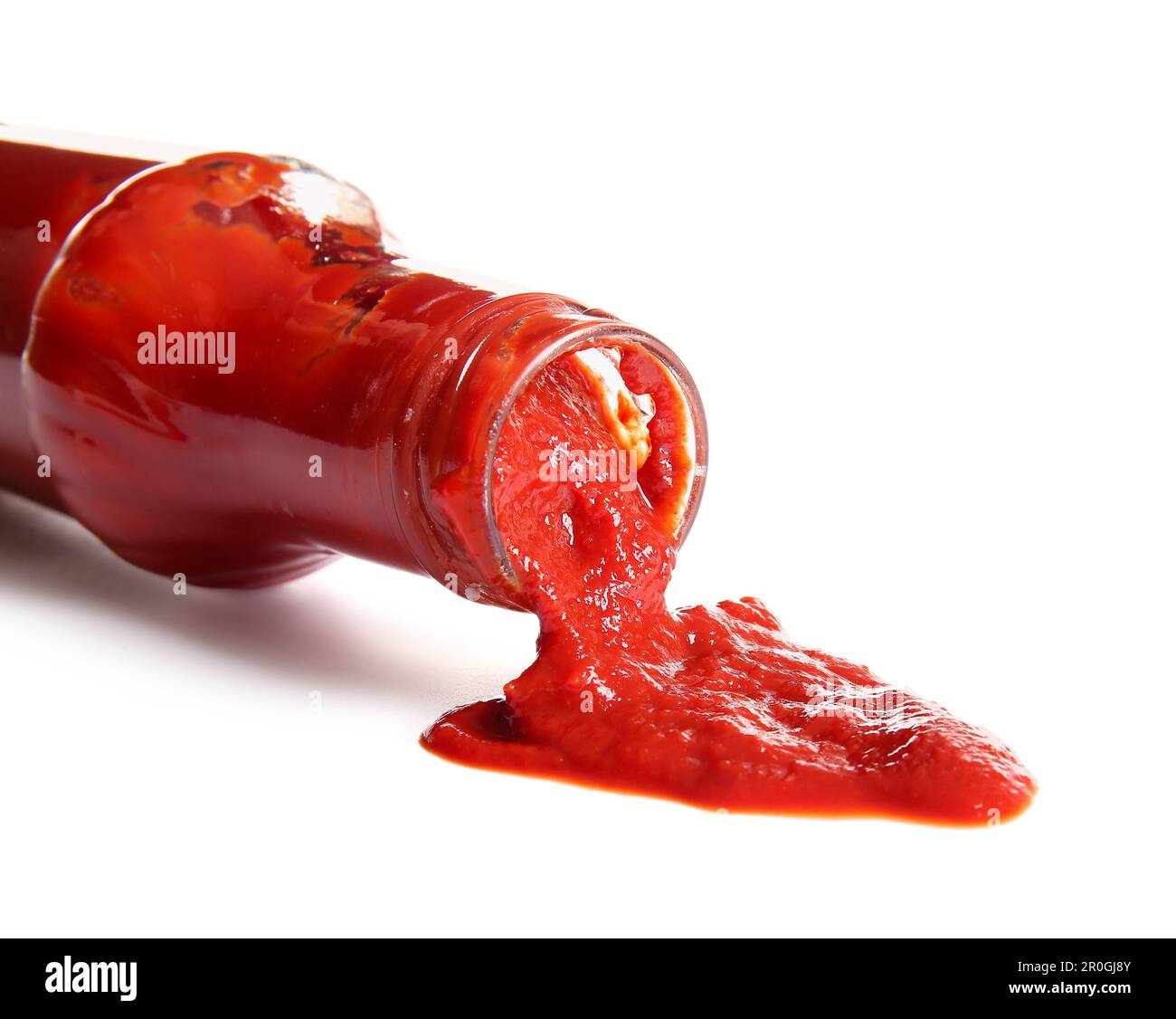 Ketchup spilled out of glass bottle on white background Stock Photo - Alamy