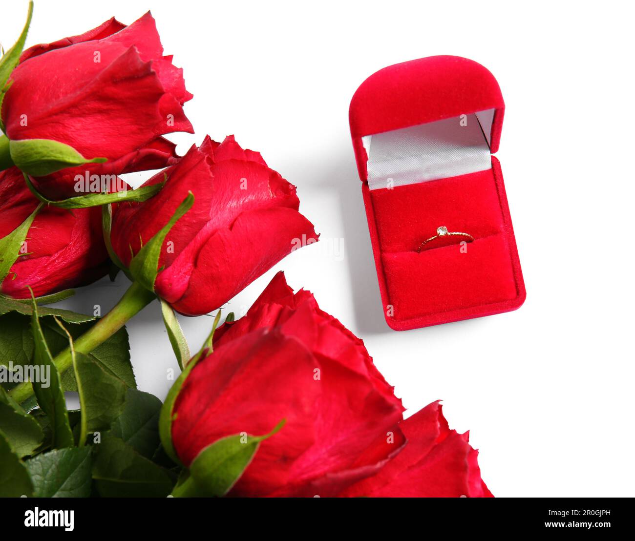 Box with engagement ring and roses on white background Stock Photo - Alamy