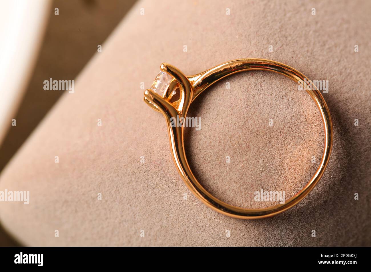 Golden engagement ring on grey box, closeup Stock Photo - Alamy