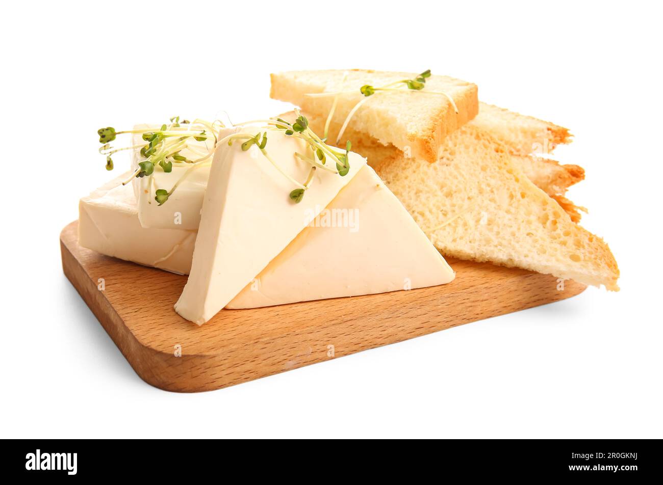 Board with processed cheese, bread and herbs on white background Stock ...