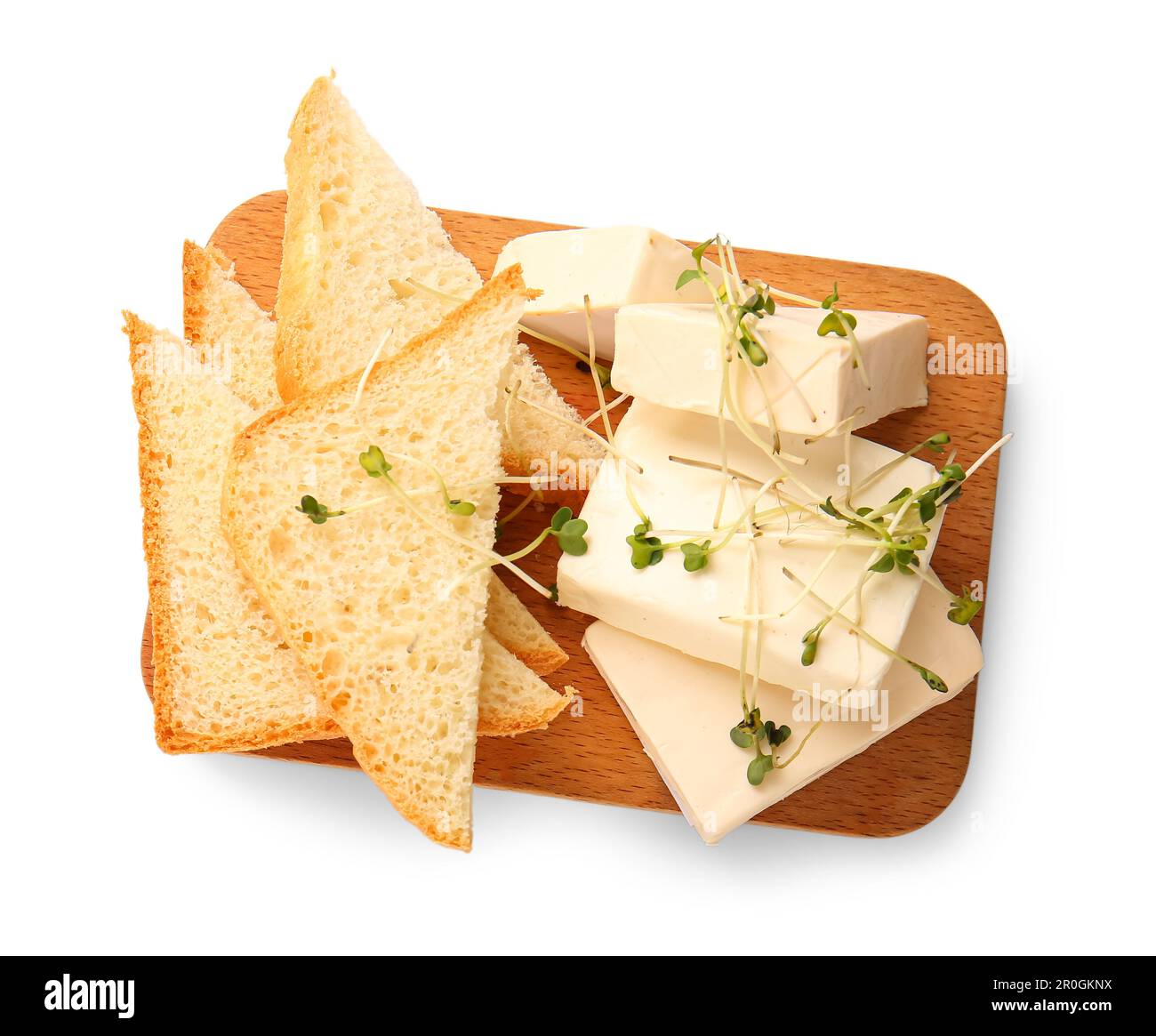 Board with processed cheese, bread and herbs on white background Stock ...