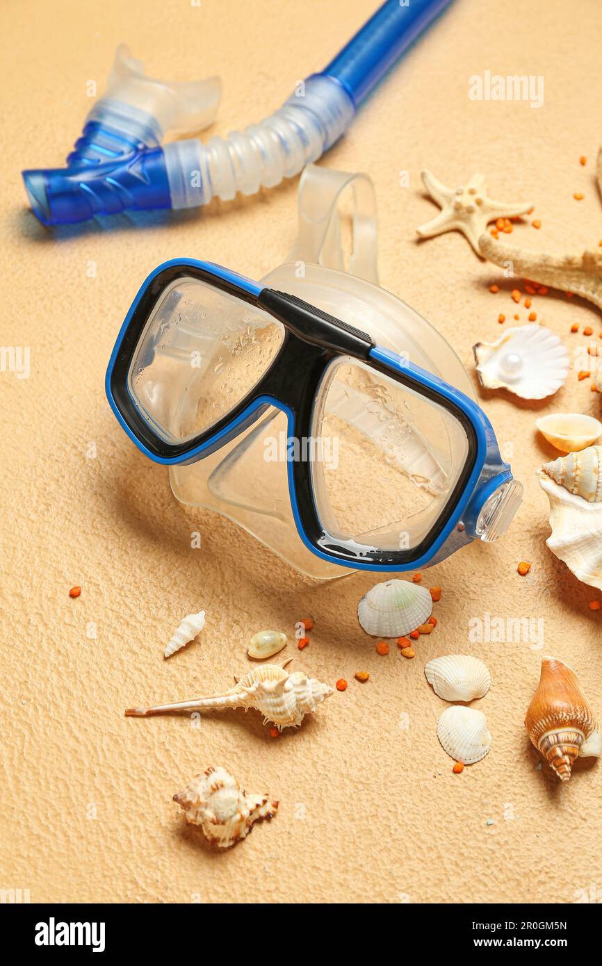 Snorkeling mask with tube, seashells and starfishes on pale orange ...