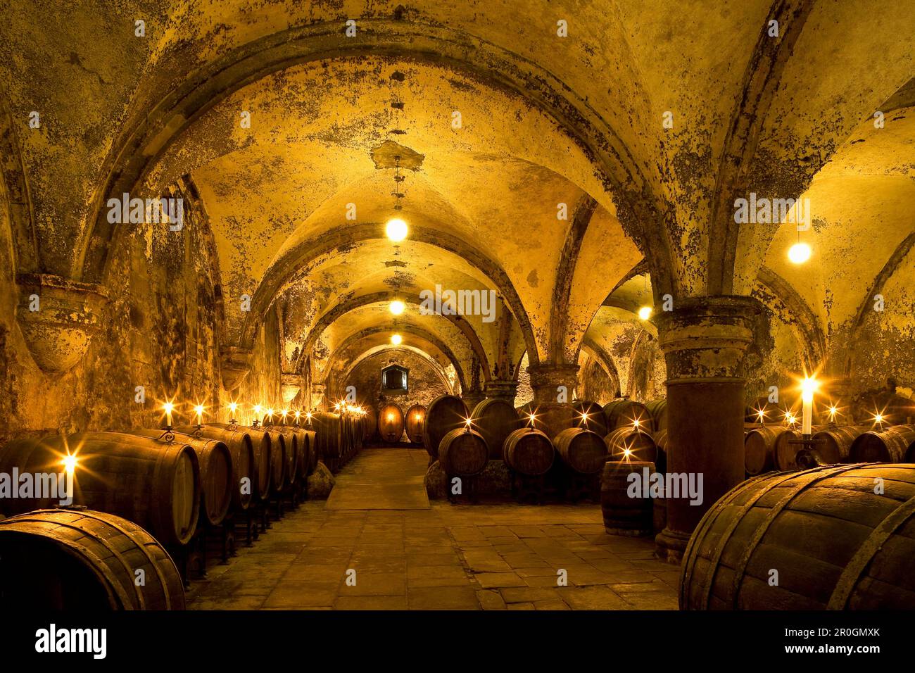 Candlelit barrels inside wine cellar of Eberbach abbey, a medieval ...