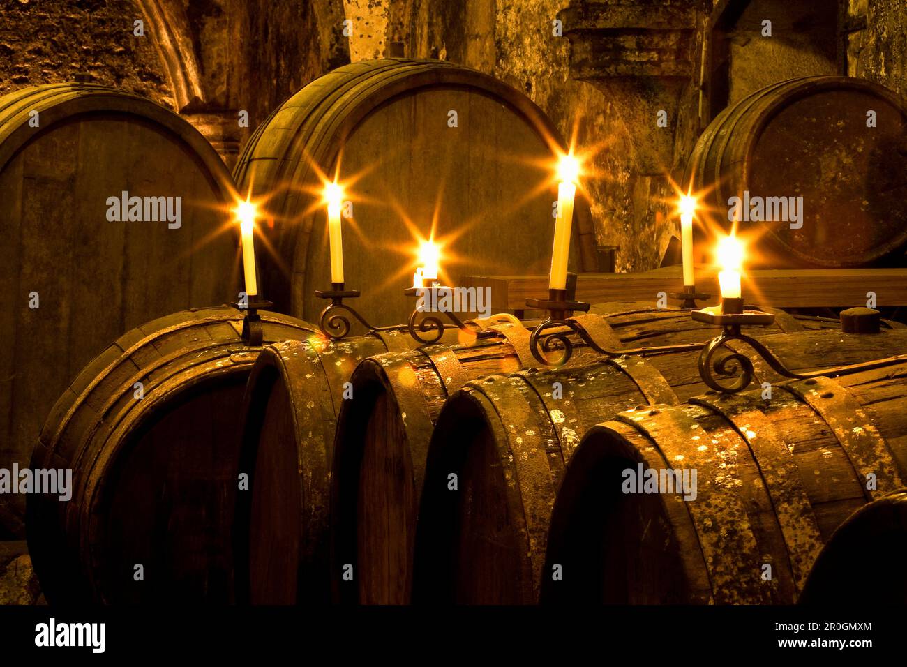 Candlelit barrels inside wine cellar of Eberbach abbey, a medieval ...
