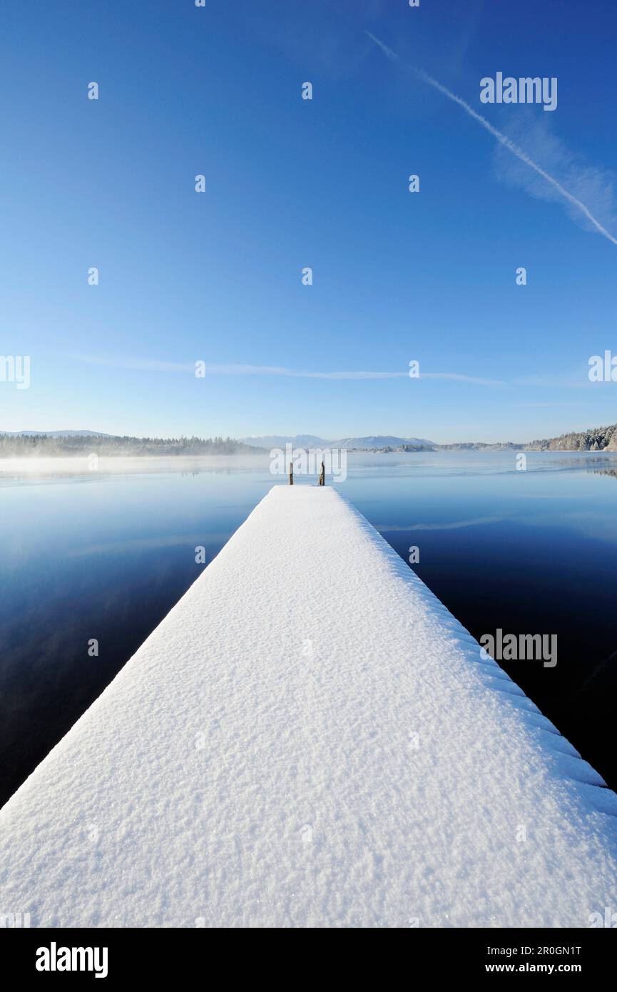 Snow covered landing stage at lake Kirchsee, lake Kirchsee, Upper ...