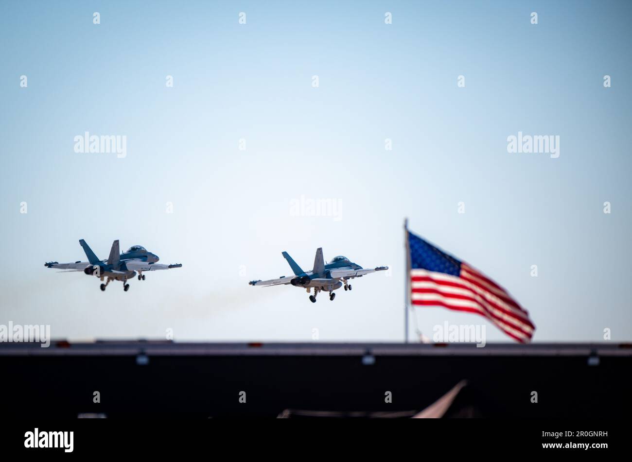 The two fighter jets soaring in the sky with an American flag in the ...