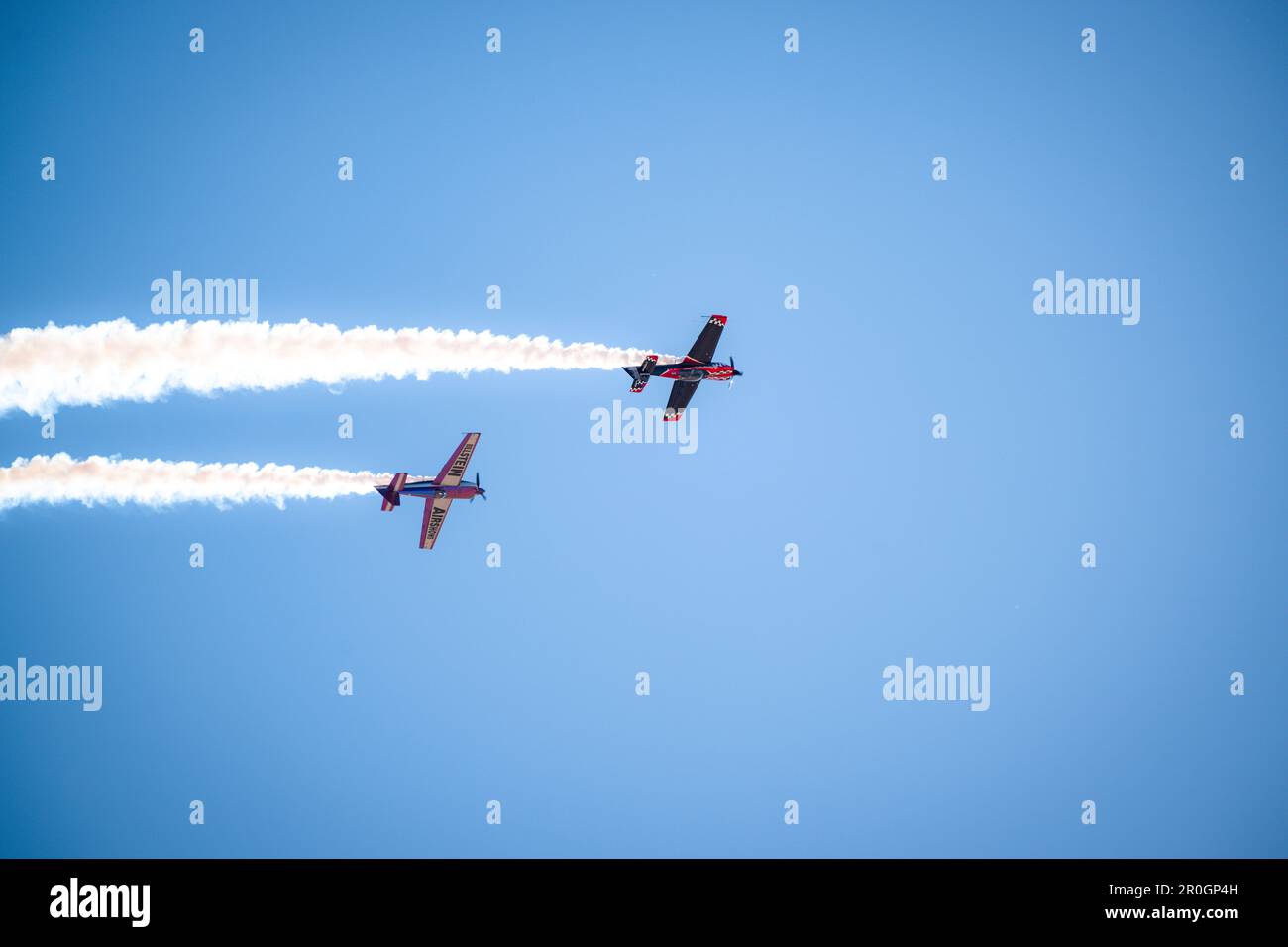 Two military fighter jets in flight performing an aerial display at an ...