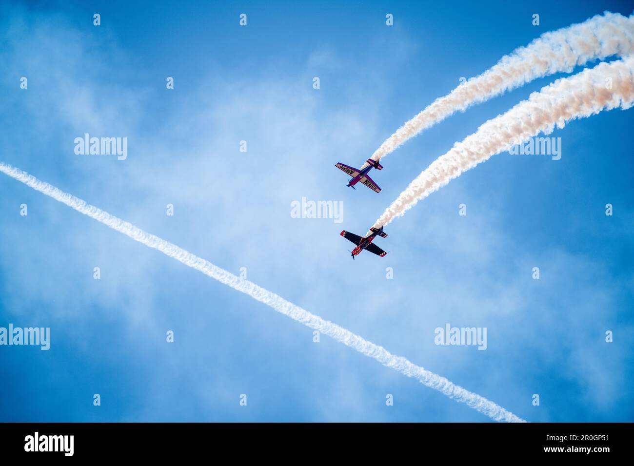 Two military fighter jets in flight performing an aerial display at an ...