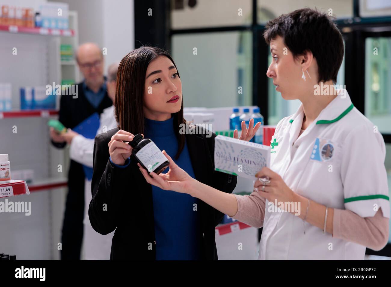 Chemist talking with drugstore client about multivitamin active ...