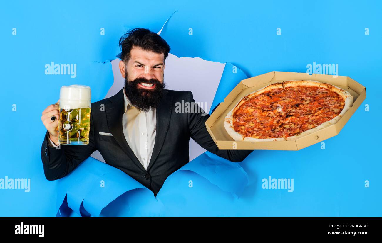 Pizza time. Happy bearded man with pizza and beer mug looking through ...