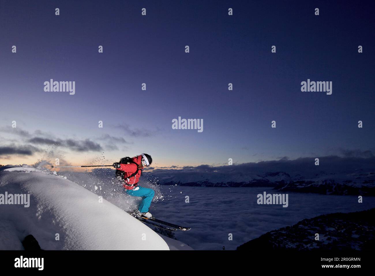 Female skier jumping in twilight, Chandolin, Anniviers, Valais ...