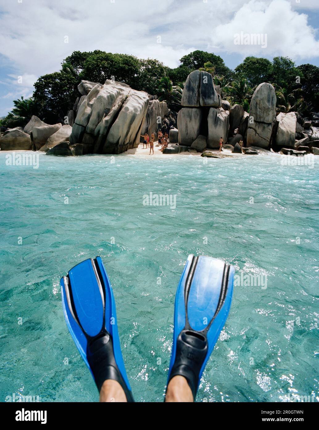 Snorkelling in shallow water over coral reef near tiny Coco Island, La ...