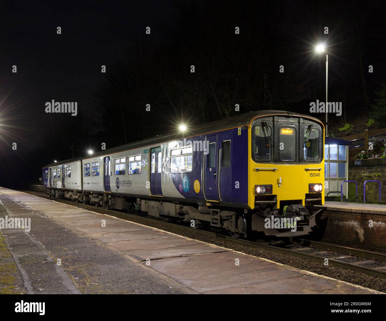 Northern Rail class 150 train 150141 calling at Westhoughton railway station on a dark night ...