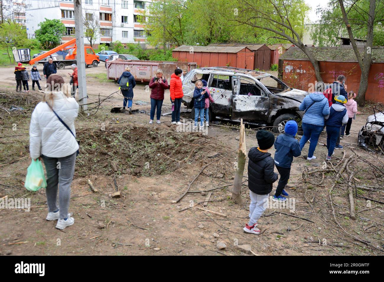 Children play next to the destroyed cars after the remains of a shot ...