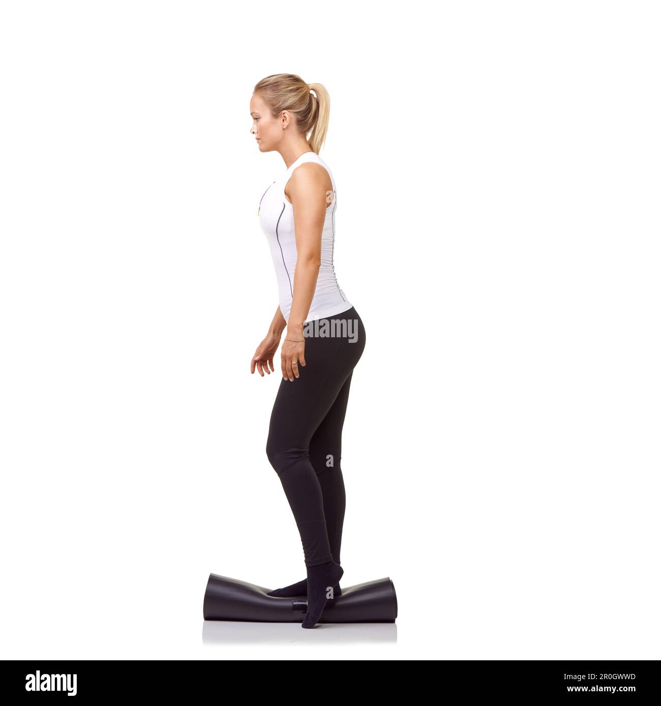 Keeping her balance. A pretty young woman balancing on her rolled up ...