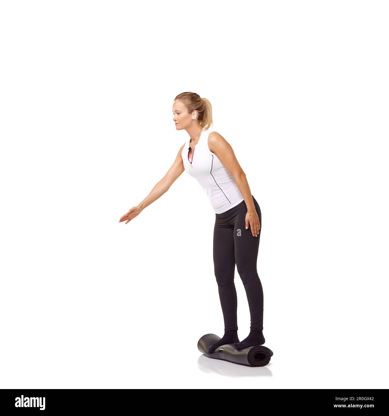 Keeping her balance. A pretty young woman balancing on her rolled up ...