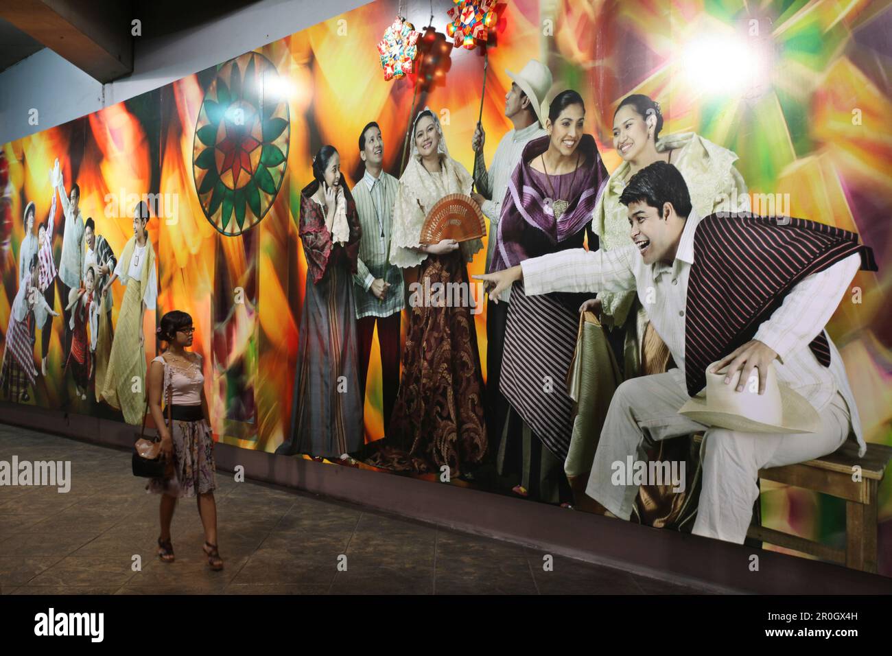 Young woman looking at a wail painting in a tunnel, Makati City, Manila ...