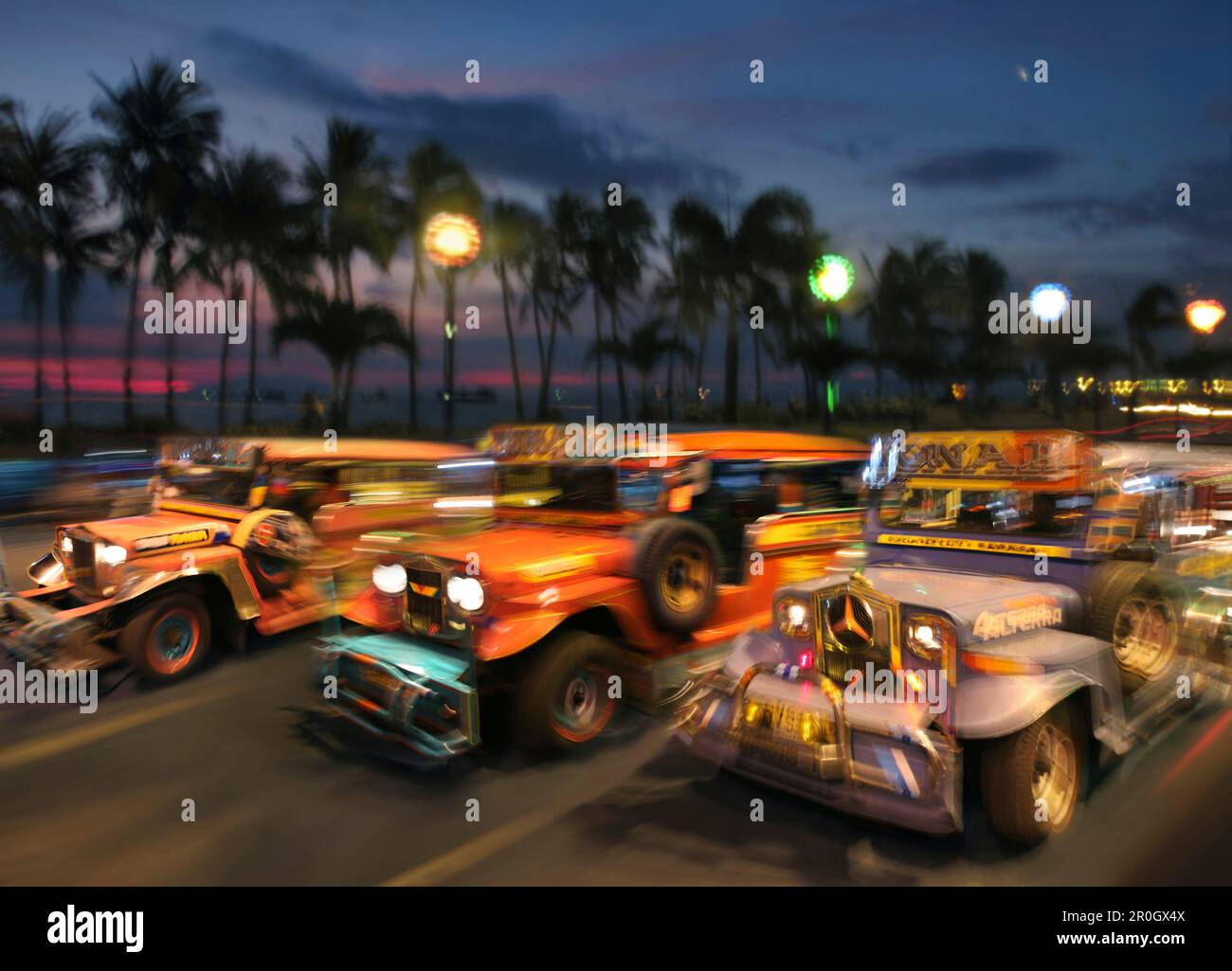 Race, Jeepneys in the street in the evening, Cebu City, Cebu Island ...