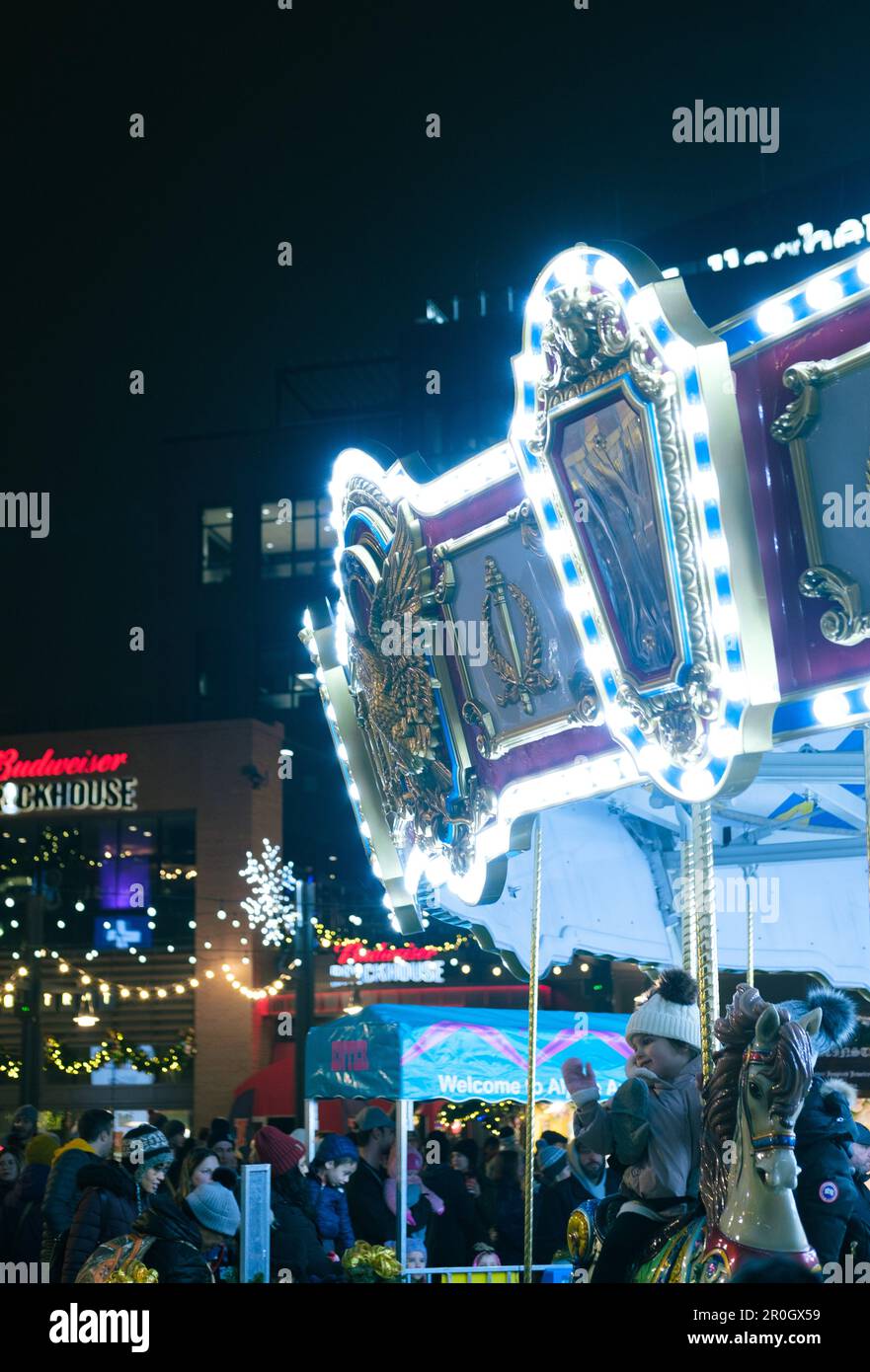 A merry-go-round illuminated by colorful lights is seen in the ...